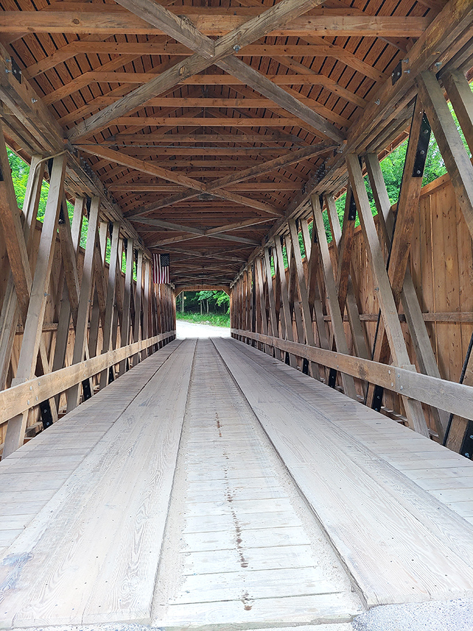 Looking down the bridge's interior is like peering through a time tunnel. Those wooden trusses have witnessed more history than your grandpa's favorite recliner.