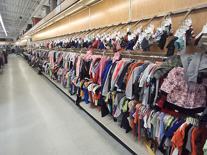 A rainbow of children's clothing stretches as far as the eye can see. One child's outgrown wardrobe becomes another family's treasure trove.