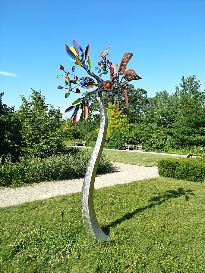This whimsical wind sculpture captures the garden's playful spirit, dancing with every breeze like a metallic celebration of creativity and nature.
