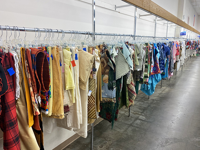 The clothing racks at Goodwill Topeka stretch like a textile rainbow, each hanger potentially holding your next favorite outfit.