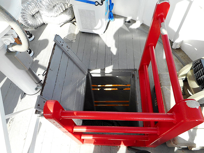 The lighthouse's maintenance access point features those fire-engine red railings&mdash;safety first, even for historical landmarks!