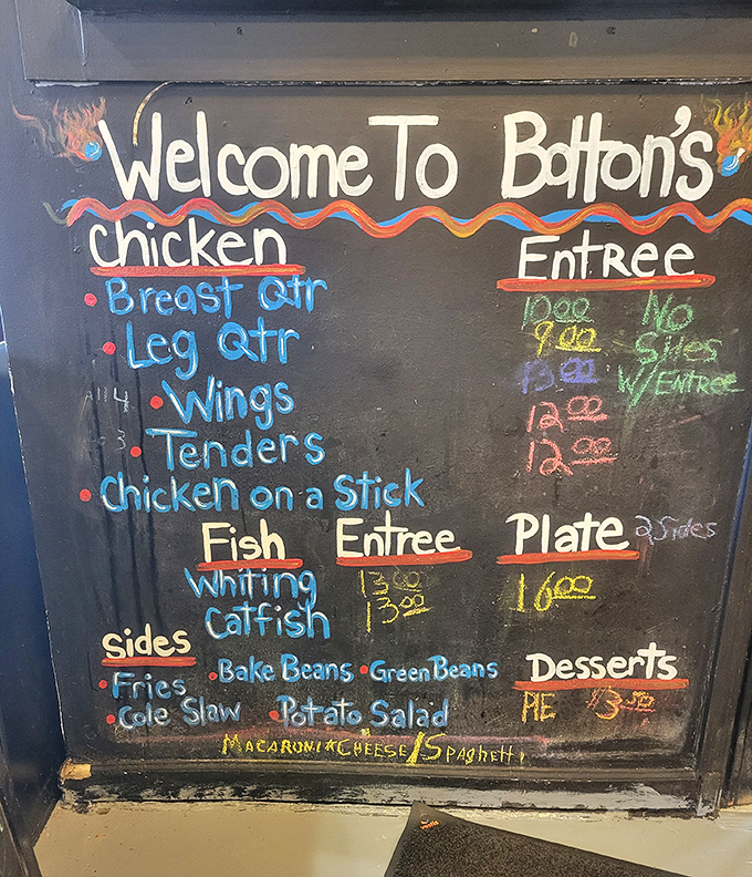 The handwritten menu board tells you everything you need to know: chicken, fish, sides, and a heat scale that doesn't mess around.