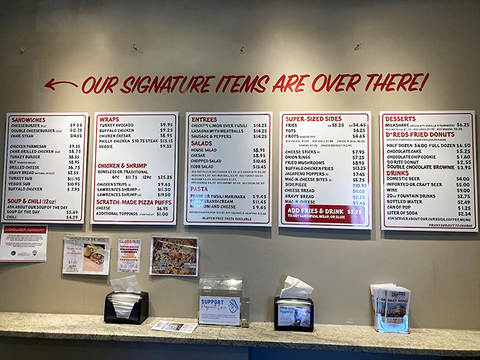 Our signature items are over there! The menu board doesn't whisper suggestions&mdash;it shouts delicious possibilities that have kept locals coming back for decades.