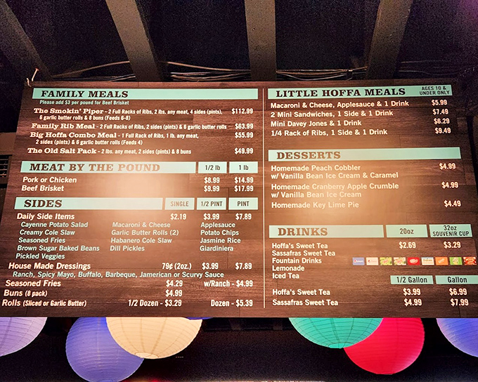 The menu board tells the real story &ndash; family meals, meat by the pound, and sides that deserve their own spotlight. Decision paralysis has never been so delicious.