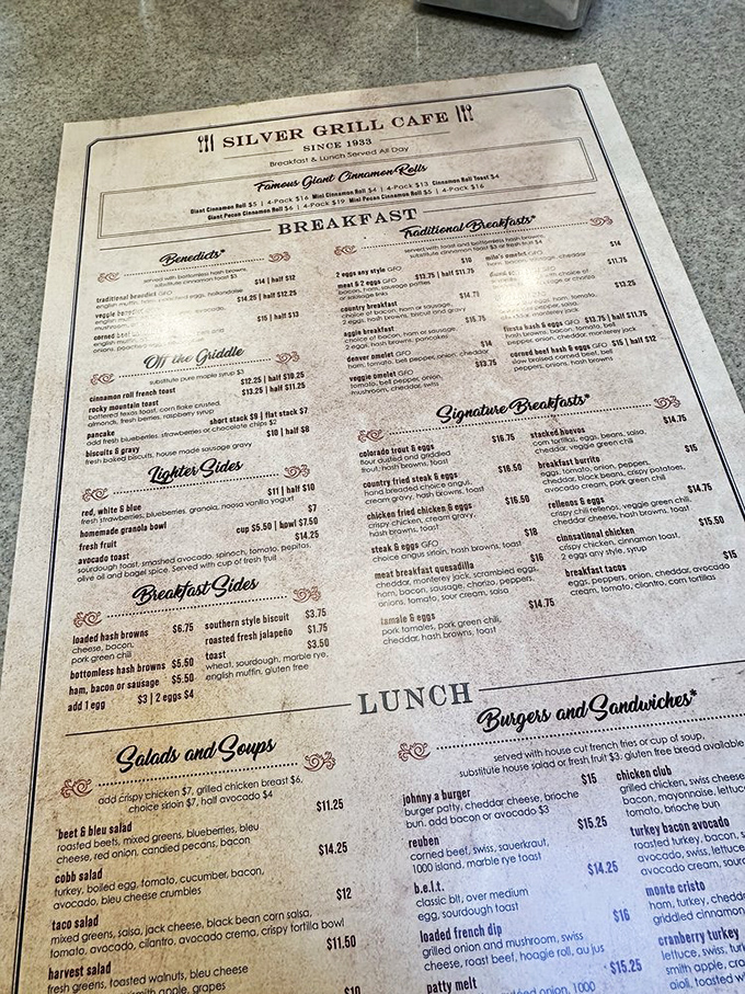 A menu that doesn't just list food but maps out pathways to happiness. The "World Famous Cinnamon Rolls" section is basically a treasure map.