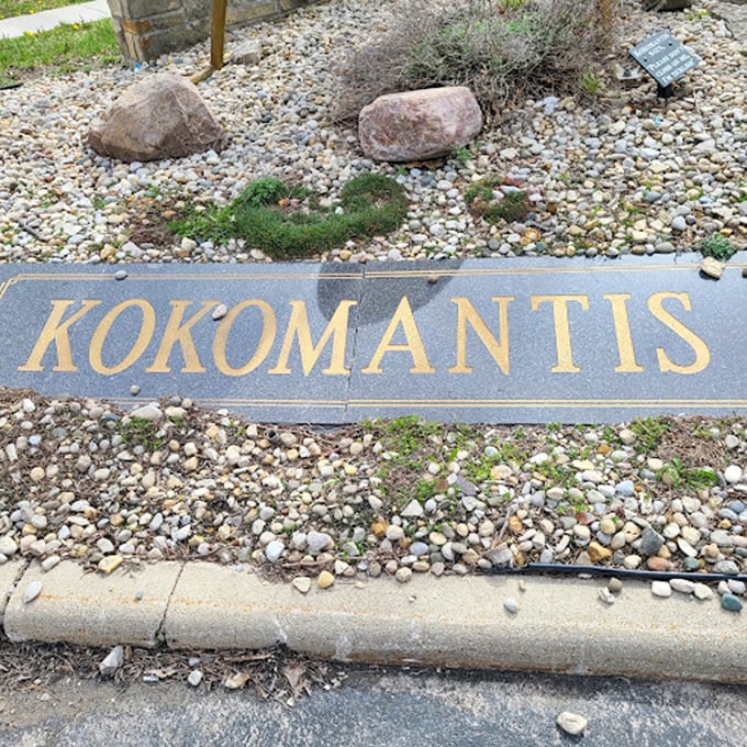 The golden nameplate gives this oversized arthropod an air of official importance, like a bug with its own congressional medal.