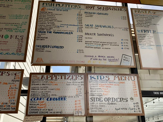 The menu board tells a story of oceanic abundance. Each handwritten item represents decades of perfecting recipes that make seafood sing.