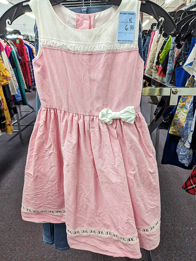 This sweet pink dress with delicate lace trim awaits its next special occasion. Cinderella's fairy godmother would approve.