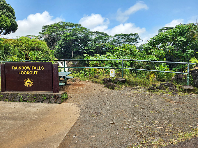 The Rainbow Falls Lookout sign stands sentinel. Behind it lies one of Hawaii's most accessible natural wonders, just steps from the parking area.
