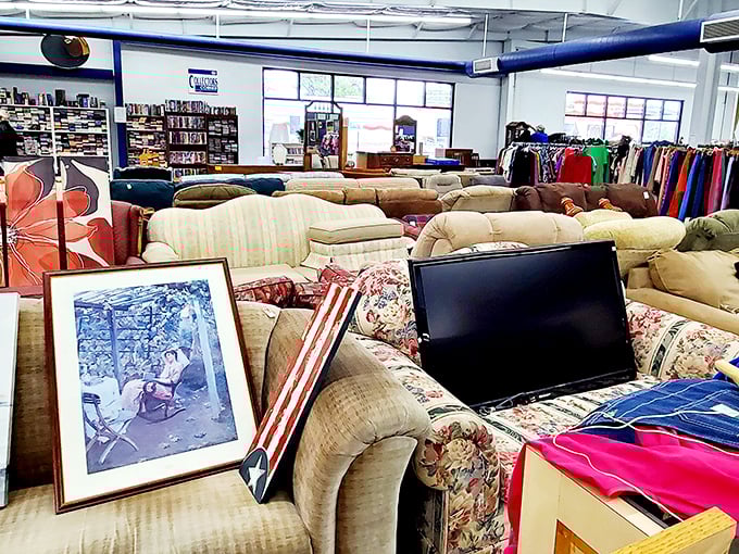 The furniture section resembles a living room time machine, where decades of comfort converge in a sea of well-loved upholstery.