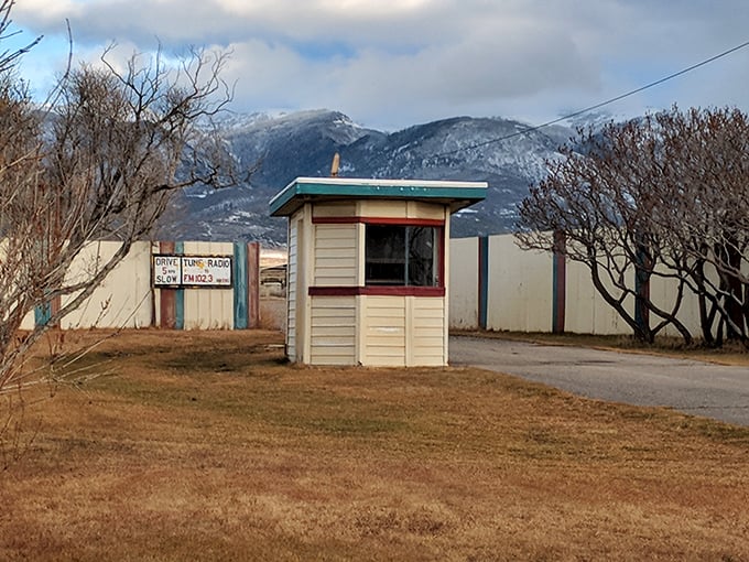 This humble ticket booth has welcomed generations of moviegoers, standing sentinel against the majestic backdrop of snow-dusted mountains.