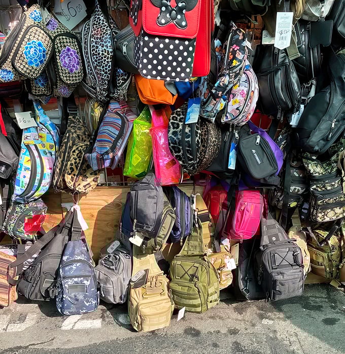 A kaleidoscope of bags dangles like colorful fruit, from practical backpacks to whimsical purses&mdash;fashion for every personality and budget.