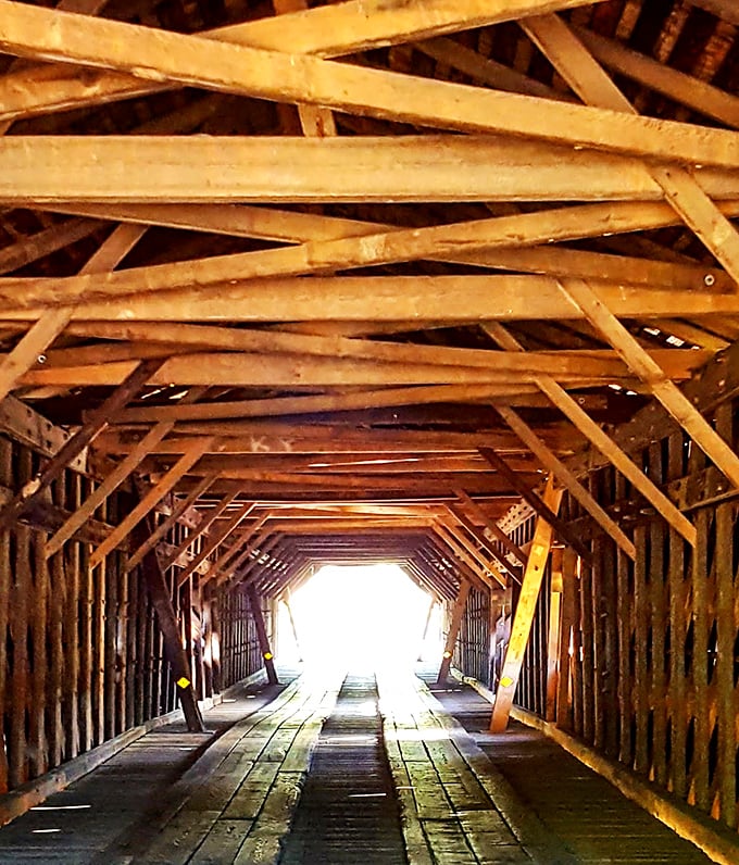 Inside the bridge, sunlight filters through wooden lattice creating a cathedral-like effect. It's Instagram before Instagram was a thing.