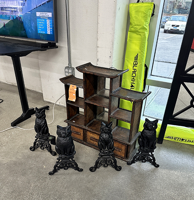 These vintage cat figurines guarding a wooden display shelf are the kind of quirky find that makes thrifting an adventure in unexpected joy.