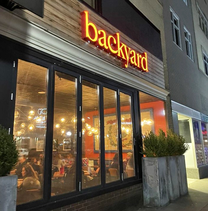 Backyard Pizza's warm glow transforms an ordinary evening into something special. The neon sign is like a lighthouse for hungry souls.