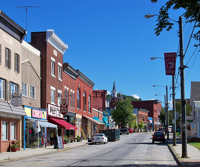 Berlin's downtown features charming brick buildings nestled against the dramatic backdrop of New Hampshire's White Mountains.