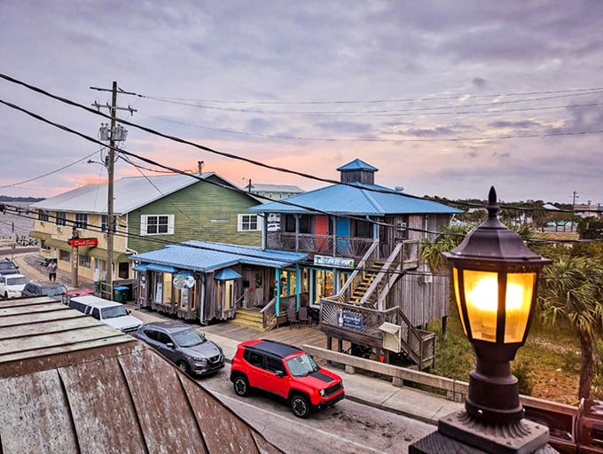 Cedar Key's waterfront buildings stand on stilts like cautious waders testing the Gulf waters, painted in colors that defy conventional taste.