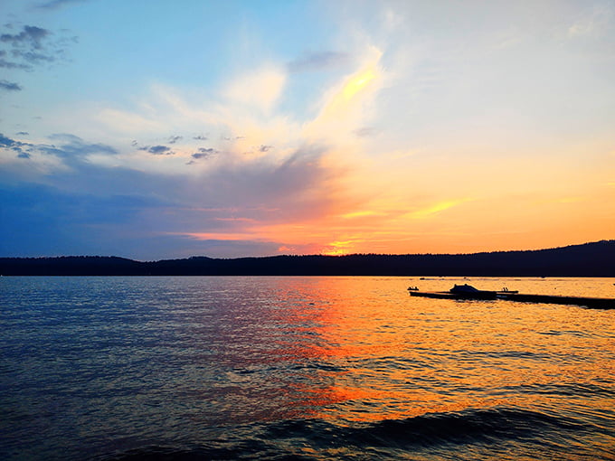 Sunset paints the water with fire. Davis Beach transforms into liquid gold as day surrenders to evening's embrace.