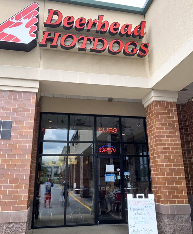 Clean, modern storefront with that unmistakable red Deerhead logo promising hot dogs done the right way since day one.