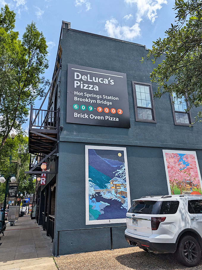 That teal exterior with vibrant art murals isn't just a building – it's a statement. Great pizza should always make an entrance!