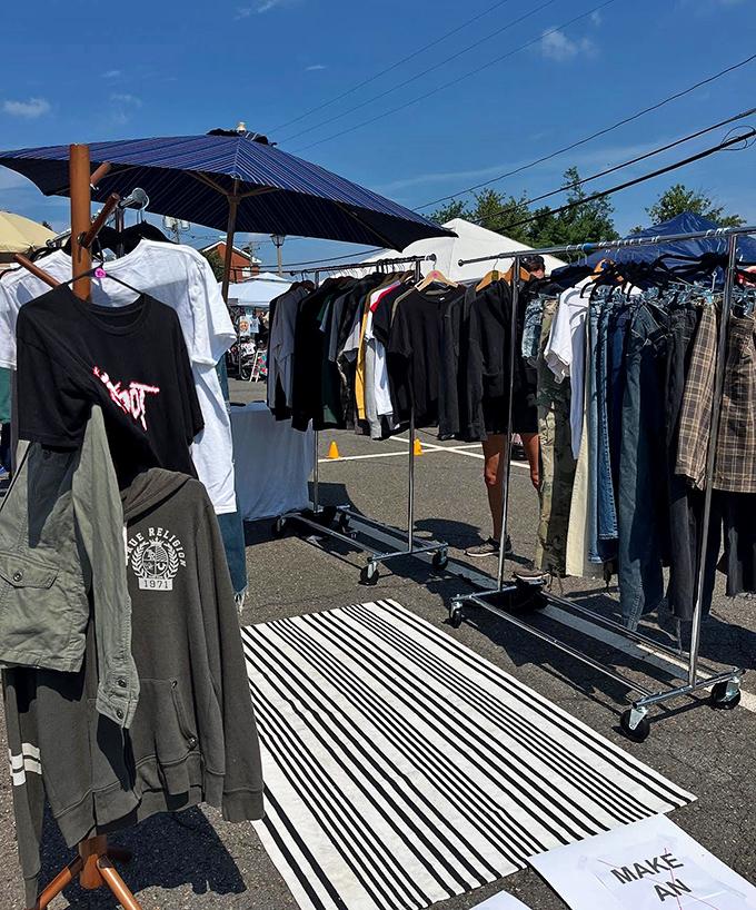 Racks of clothing under blue canopies at Fairfax Funky Flea, where vintage finds and modern styles attract fashion-hunting shoppers.
