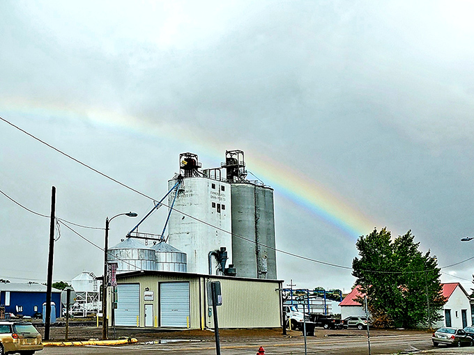 Industrial silos under a rainbow sky in Glasgow &ndash; where practical architecture meets Montana's magical natural light shows.