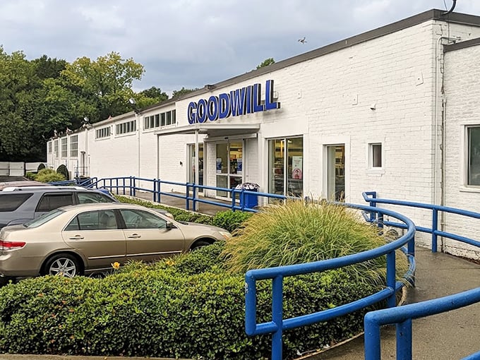 Goodwill's crisp white building with blue accents stands ready to welcome bargain hunters and donation-droppers alike.