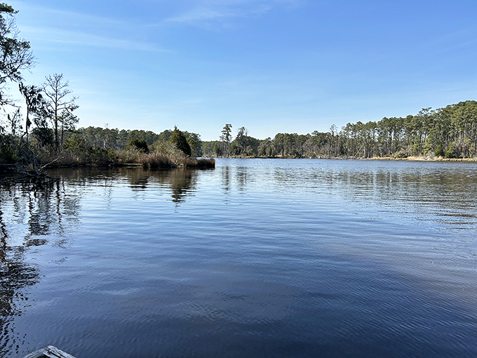 Peaceful waters mirror the sky in this coastal paradise where time moves slowly.