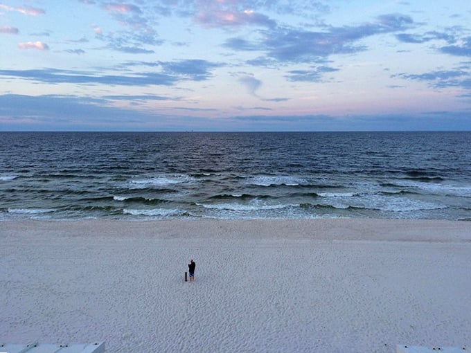 Twilight magic at West End Public Beach. The vast expanse of pristine sand meets gentle Gulf waves under a cotton candy sky.