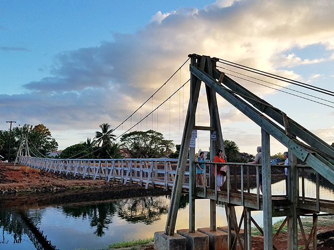 The iconic swinging bridge of Hanapēpē invites adventurous souls to cross the gentle river below.
