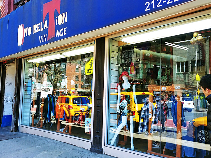 Blue facade, yellow reflections, infinite possibilities! No Relation Vintage's window mannequins silently judge your outfit while NYC's vibrant street life dances in the glass.