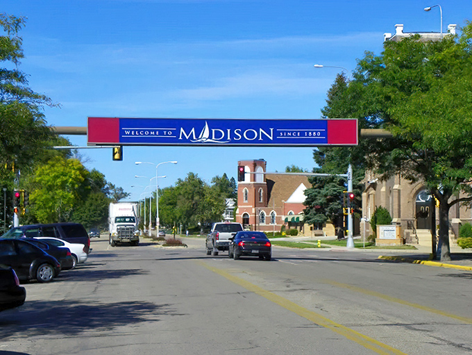 Madison welcomes visitors with a splash of small-town pride, where the sailboat logo hints at nearby Lake Herman's affordable recreation options.