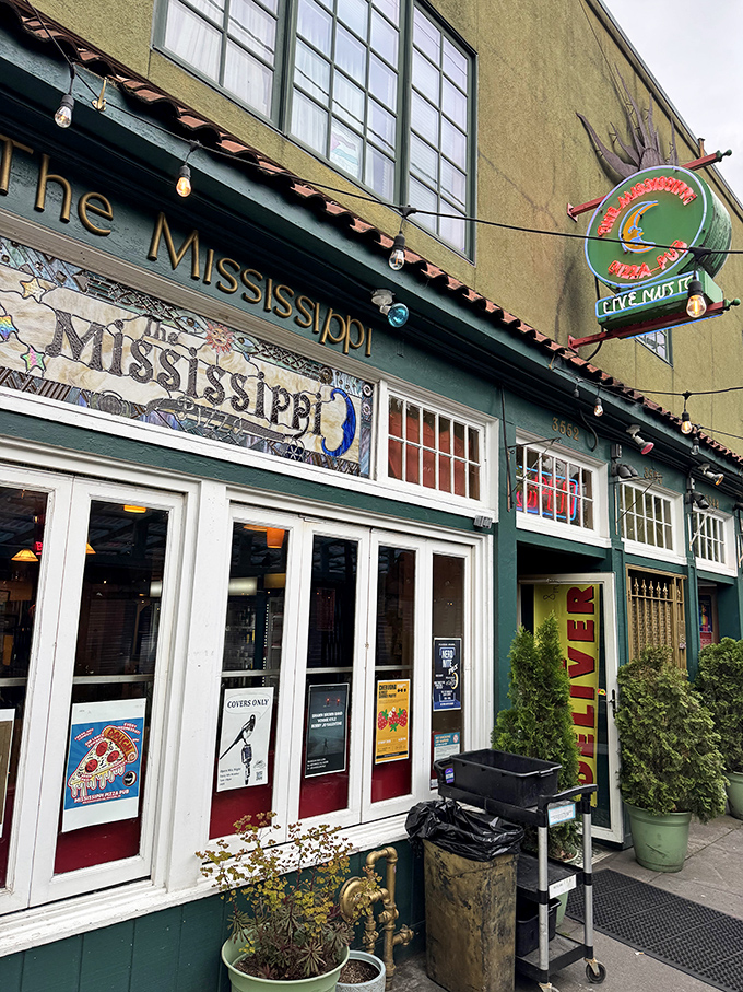The Mississippi Pizza sign glows like a beacon for hungry souls seeking both great pies and live entertainment.