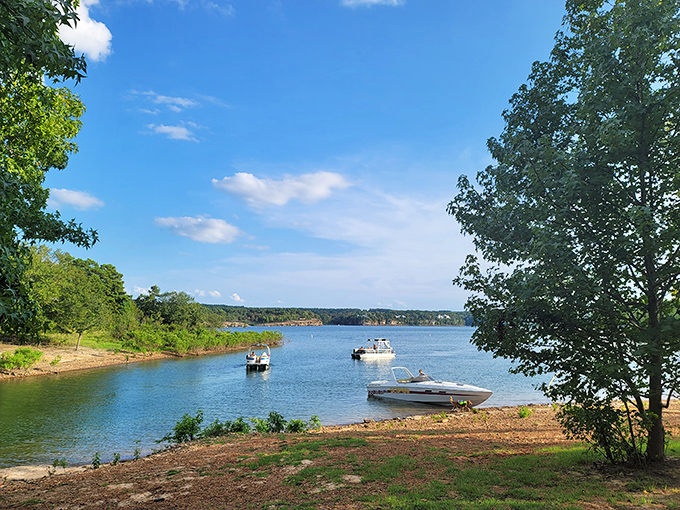 Boats gently bobbing on crystal-clear waters at Old Highway 25 Park Beach. Nature's perfect postcard moment in Tumbling Shoals!