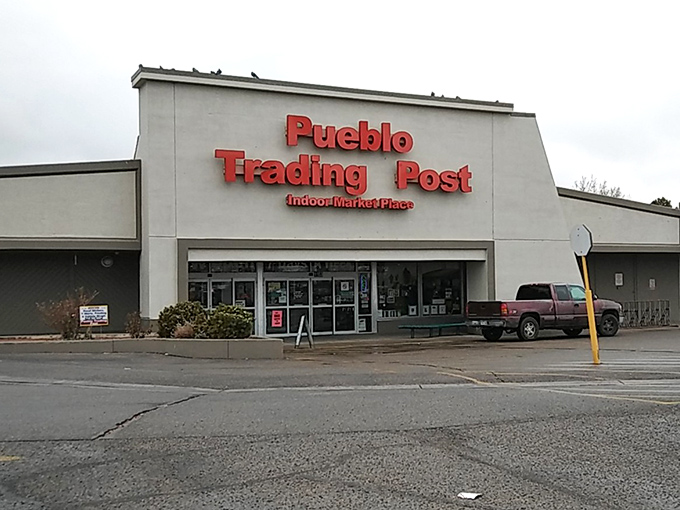 Pueblo Trading Post stands proud! That bold red signage promises seven days of treasure hunting possibilities under one roof.