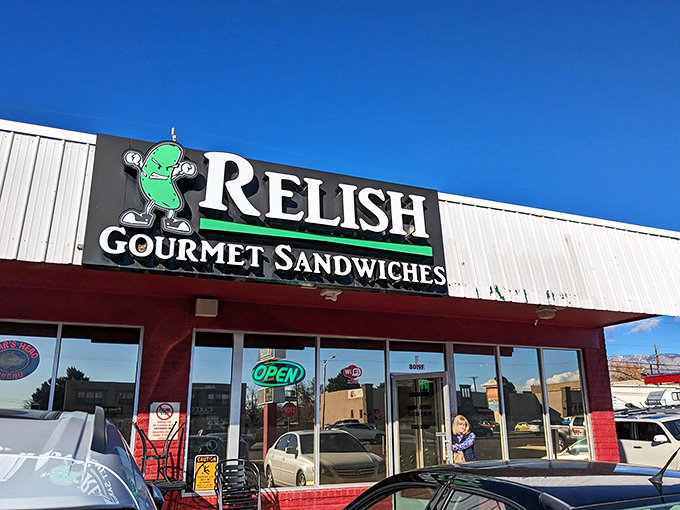 Relish's playful pickle mascot sets the tone for a sandwich experience that's anything but ordinary.