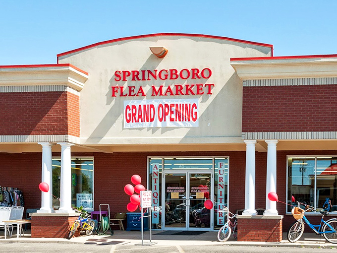 The bright red Springboro Flea Market sign promises treasure hunting adventures behind those welcoming doors. Bargain paradise awaits!