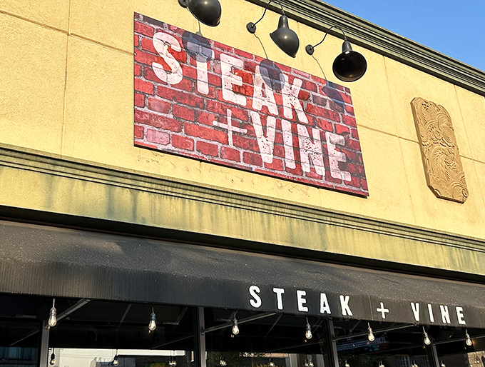 Steak + Vine announces itself boldly against the brick facade. The plus sign isn't math&mdash;it's a promise of perfect pairing.