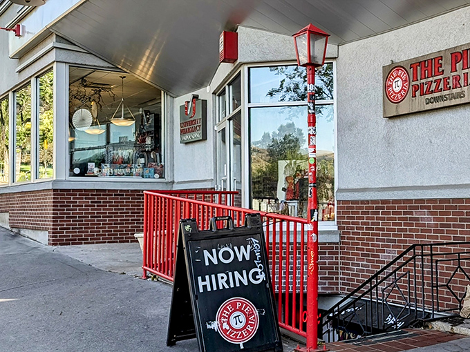 The Pie Pizzeria's charming storefront with its red railings feels like a pizza speakeasy. Follow the "Now Hiring" sign to flavor town!