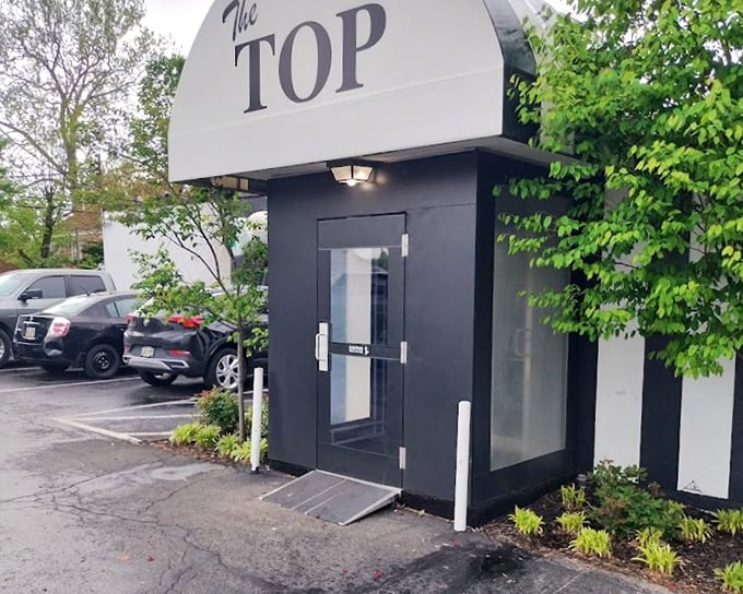 The Top's vintage entrance whispers of Sinatra's era. Step inside and find yourself transported to when steaks and martinis ruled the evening.