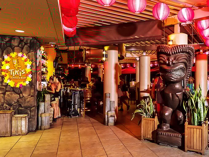 Step into tiki paradise where paper lanterns cast a ruby glow and carved guardians watch over your mai tai. Indiana Jones would approve of this tropical treasure!