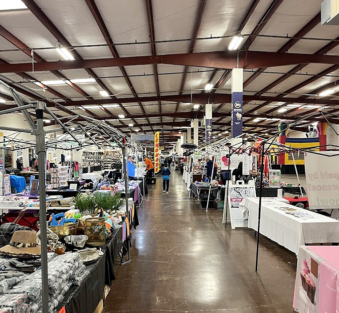 A bustling indoor aisle at the Tupelo Flea Market, lined with vendors showcasing everything from handmade goods to collectibles—treasure hunting at its finest.