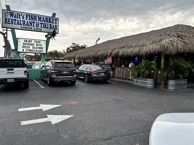 Walt's Fish Market's tiki-covered entrance beckons hungry seafood lovers. This Sarasota institution offers the perfect blend of market-fresh fish and vacation vibes.