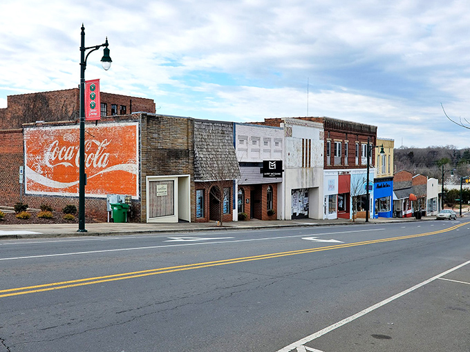 This vintage Coca-Cola mural tells the story of a town where prices haven't inflated faster than a parade balloon.