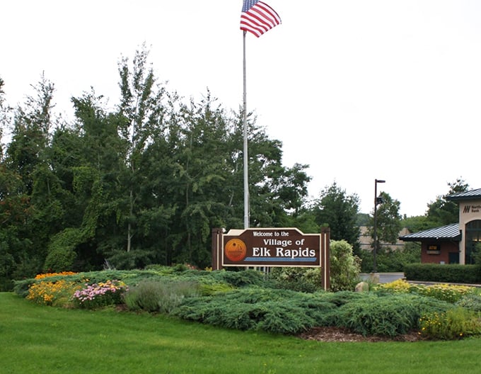 Aerial view of Elk Rapids &ndash; where water surrounds and housing prices don't drown you. Blue waters, green trees, affordable living.