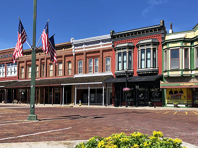 Fort Scott&rsquo;s historic downtown charms with its colorful storefronts, brick streets, and timeless small-town pride waving in the breeze.