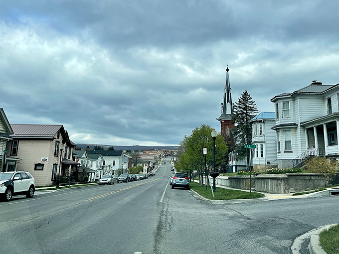 Dramatic skies frame Frostburg's hillside vista, where church steeples punctuate the skyline like exclamation points.