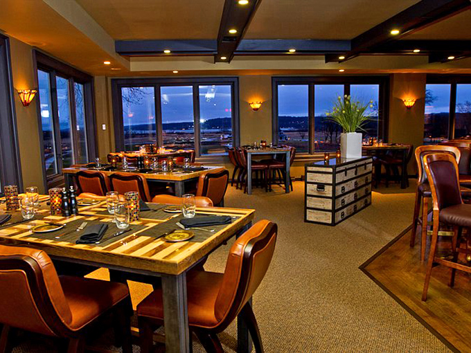 Inside Hunt Club, every table feels like the best seat in the house. Those windows frame the sunset like nature's dinner theater.