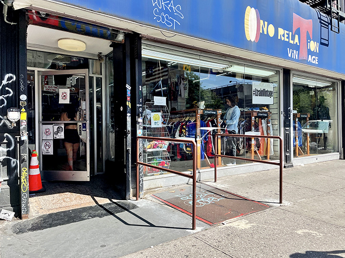 Urban treasure cave with sidewalk appetizers! L Train Vintage's blue storefront welcomes fashion archaeologists with a metal ramp runway to style salvation.