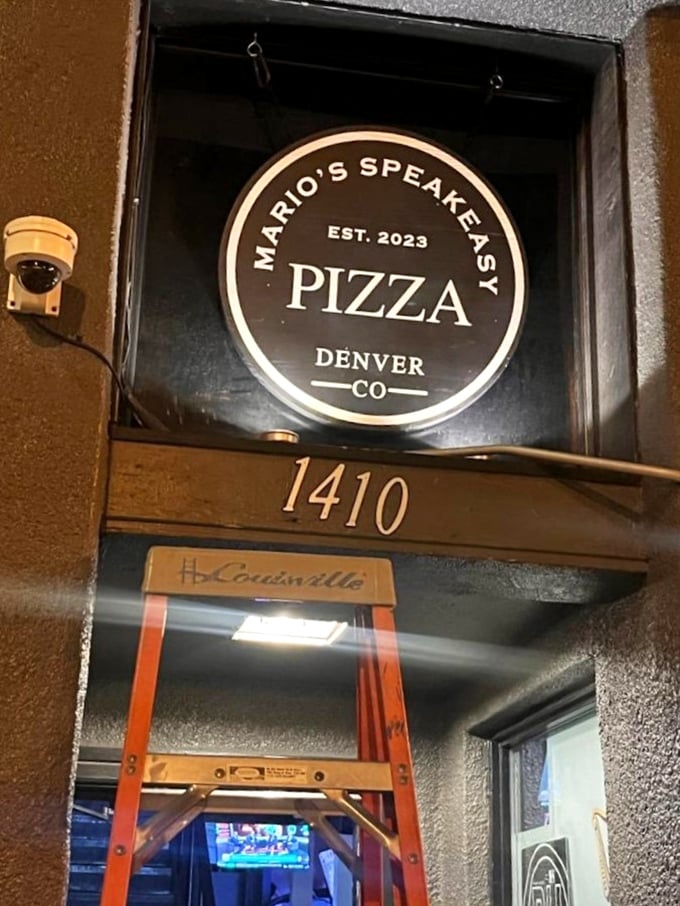 The discreet signage of Mario's Speakeasy Pizza promises an underground pizza experience. Gatsby would approve of this hidden gem.